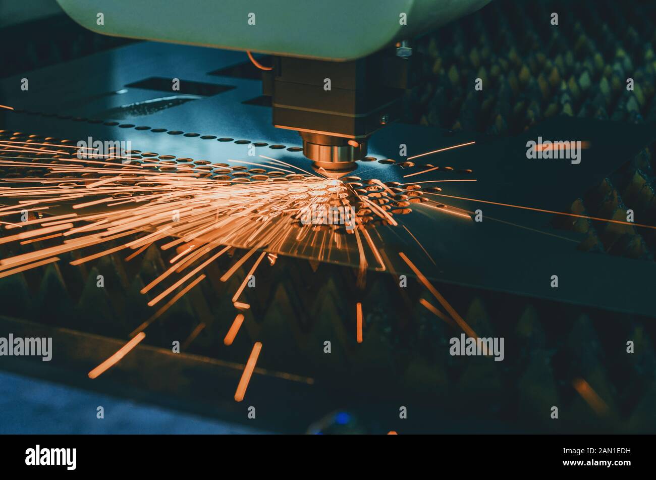 Machine for laser cutting of metal. Laser head cuts the sheet with a ...