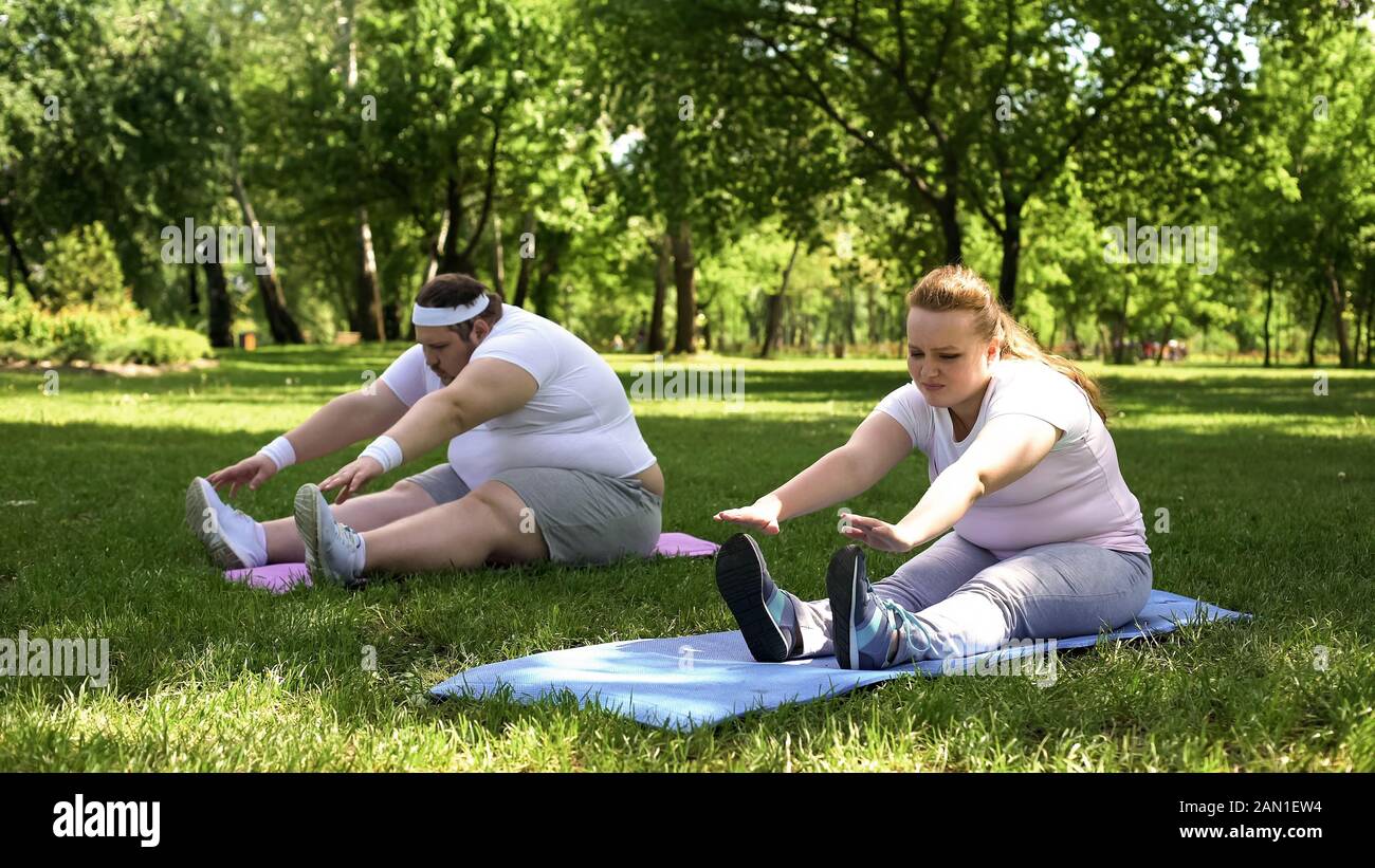 Obese couple doing exercises, starting together healthy lifestyle ...
