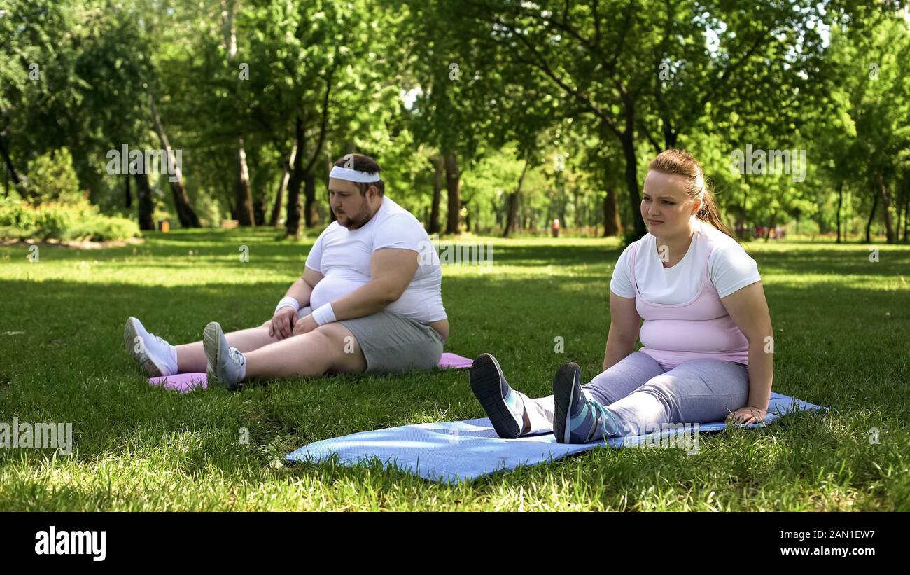 Obese couple resting after hard training, lack of motivation, weight ...