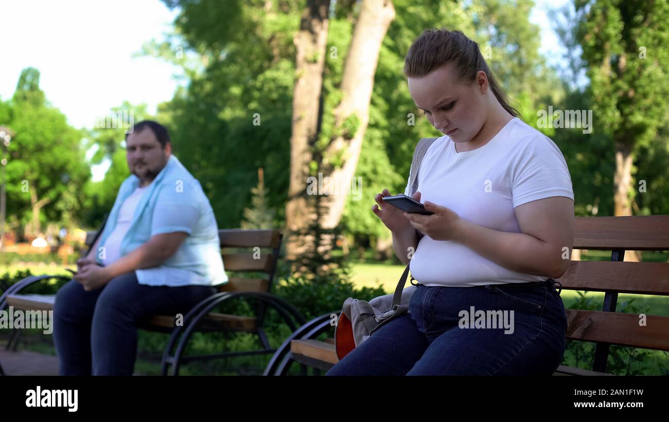 Fat man shy to get acquainted with pretty woman, lady chatting with ...