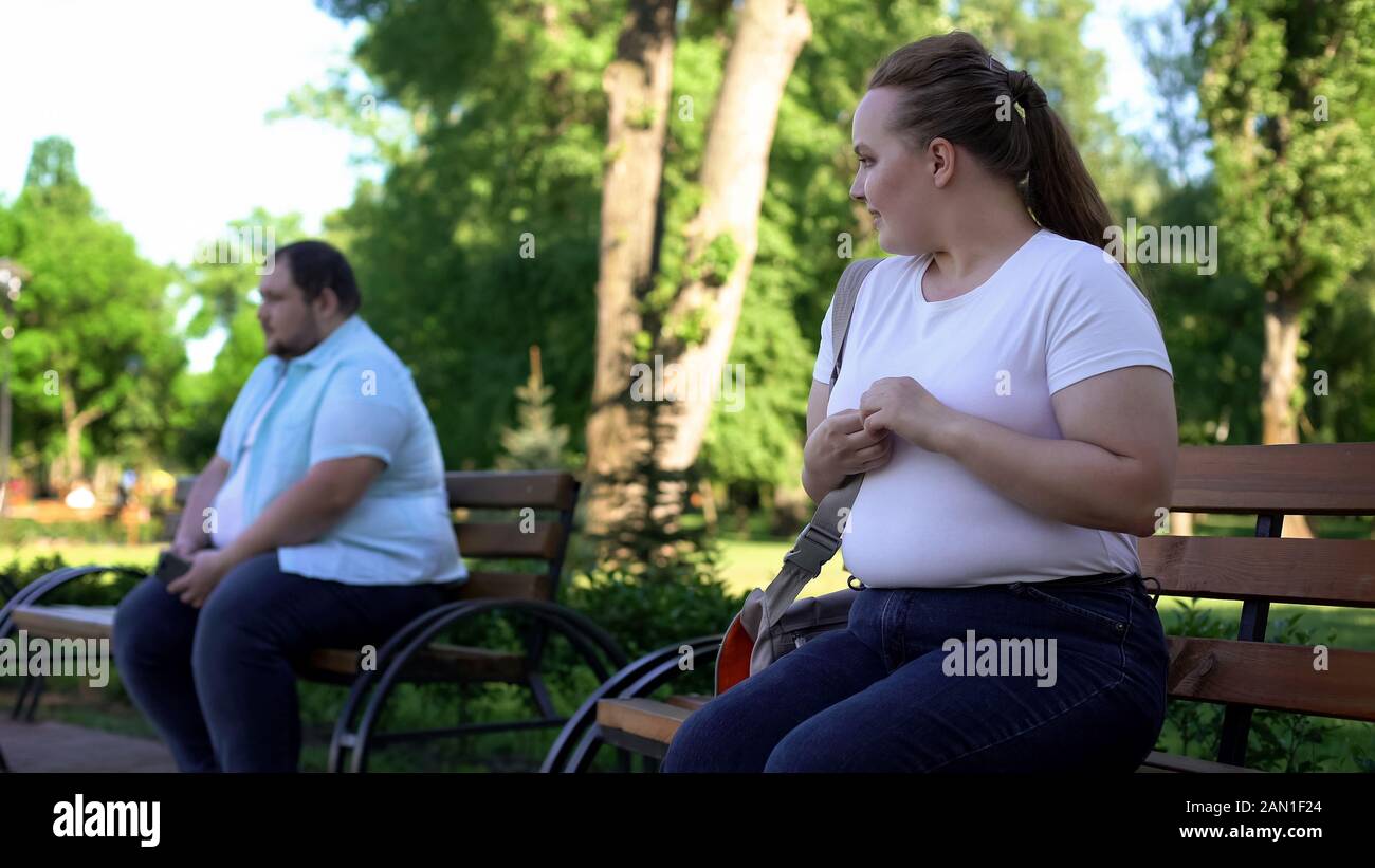 Obese lady flirting with fat insecure man, afraid to get acquainted ...