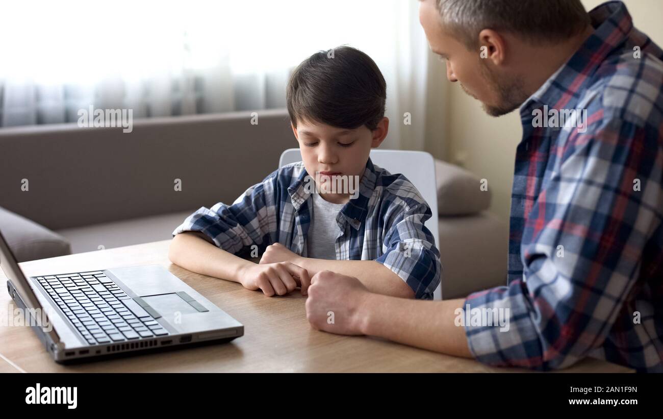 Strict father scolding his little son for computer addiction, family ...
