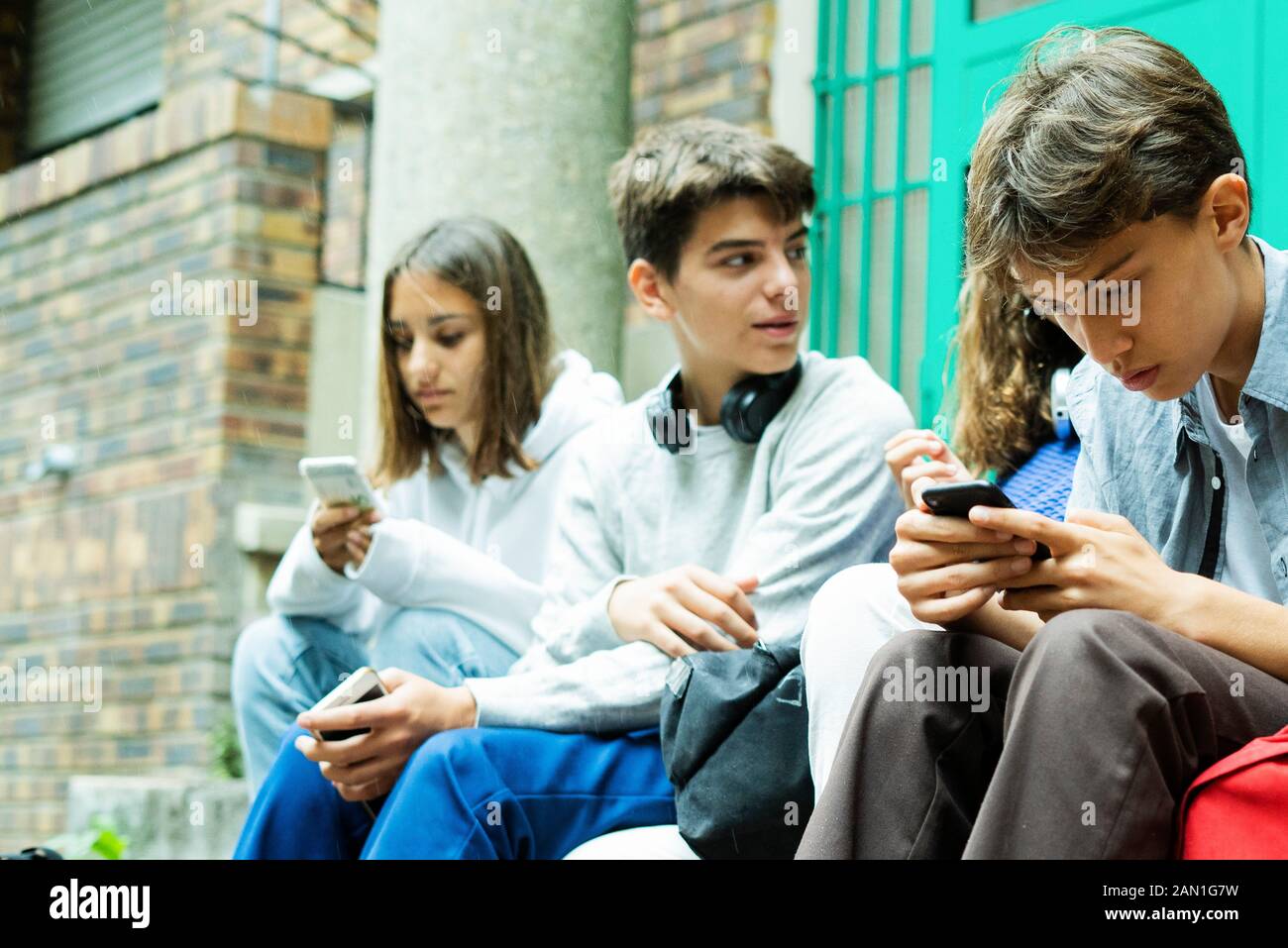 Friends using smartphones Stock Photo - Alamy