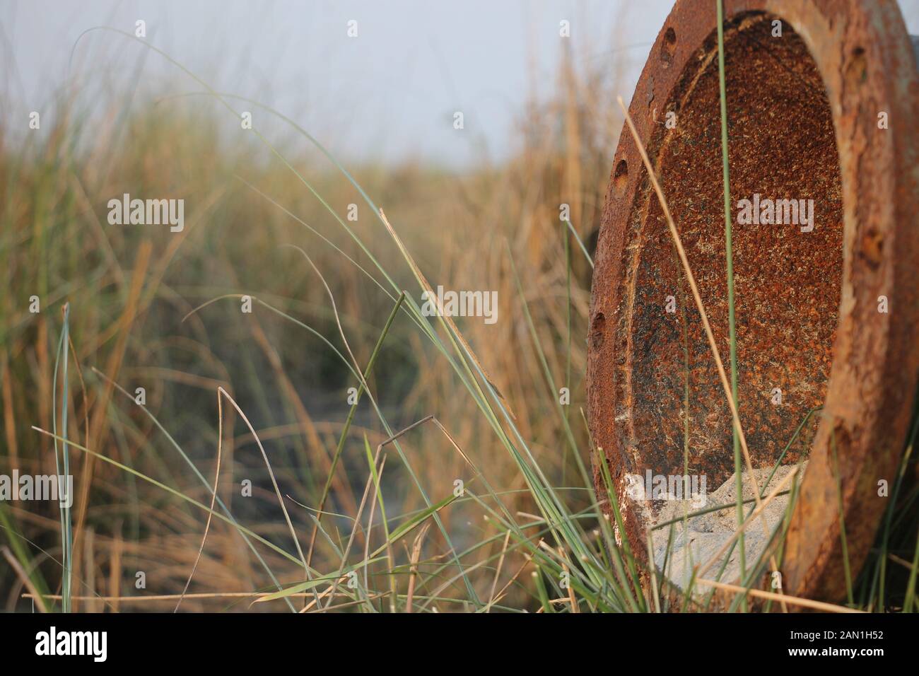 Rusted iron pipe lying on sand beside river for ditching river with ...