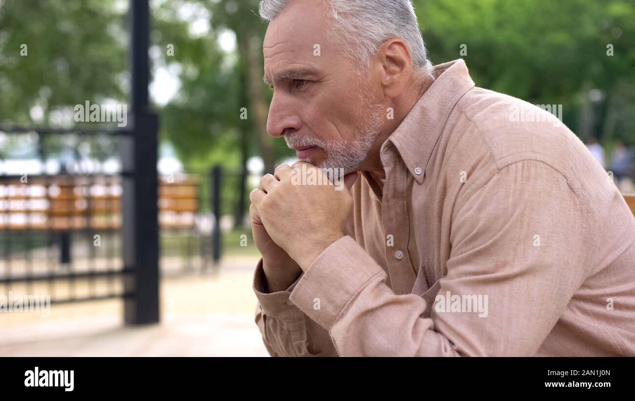 Depressed old male crying on park bench alone, retirement problems ...