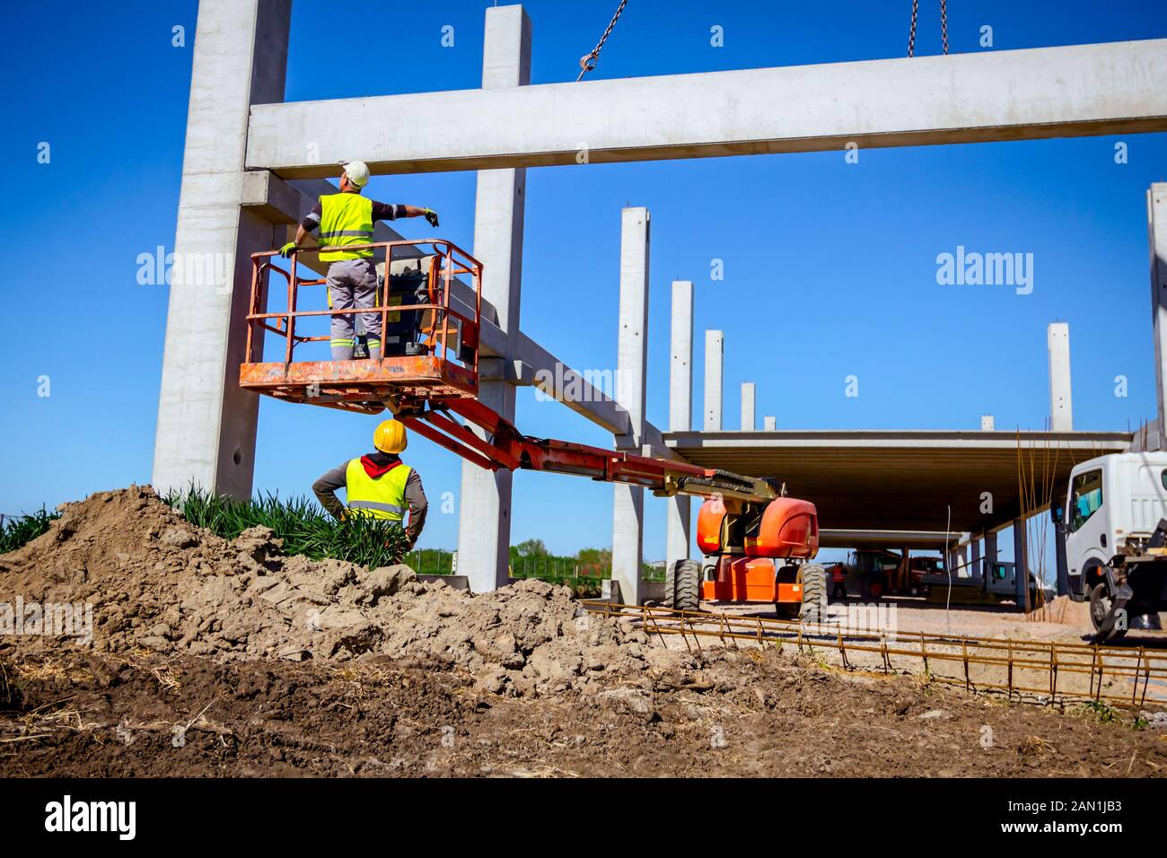 View from behind on construction worker with safety vest and yellow ...