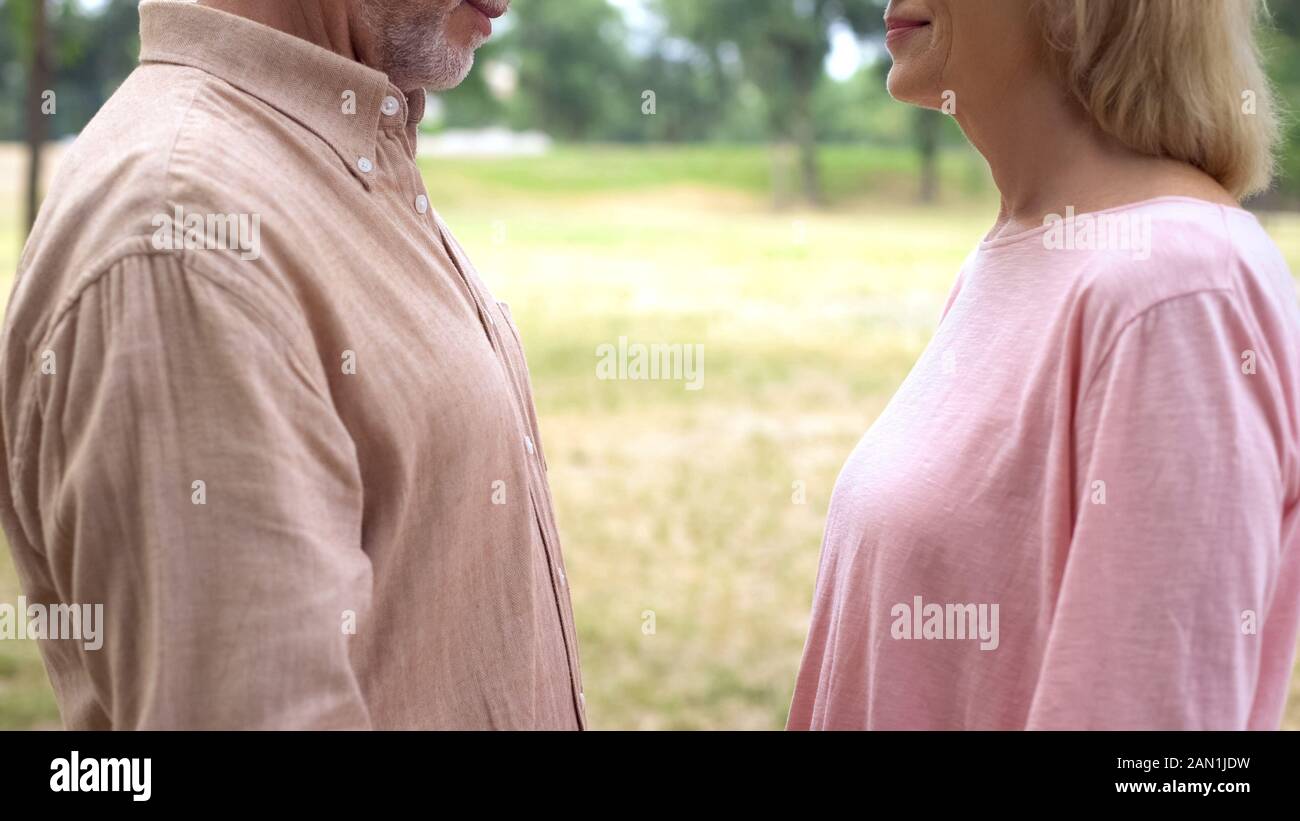 Elderly man and woman looking each other, romantic meeting in ...