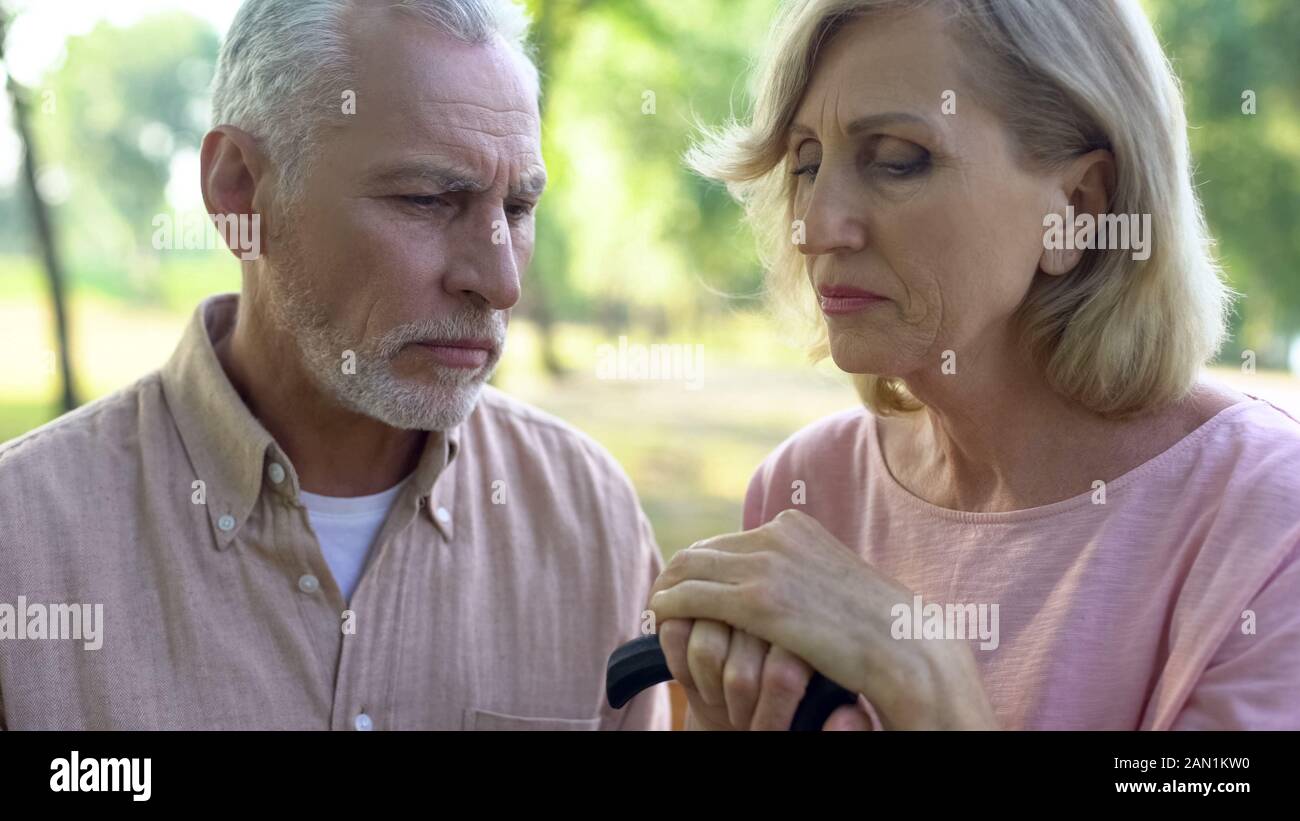 Sad pensioner couple sitting bench, retirement poverty, health problem ...