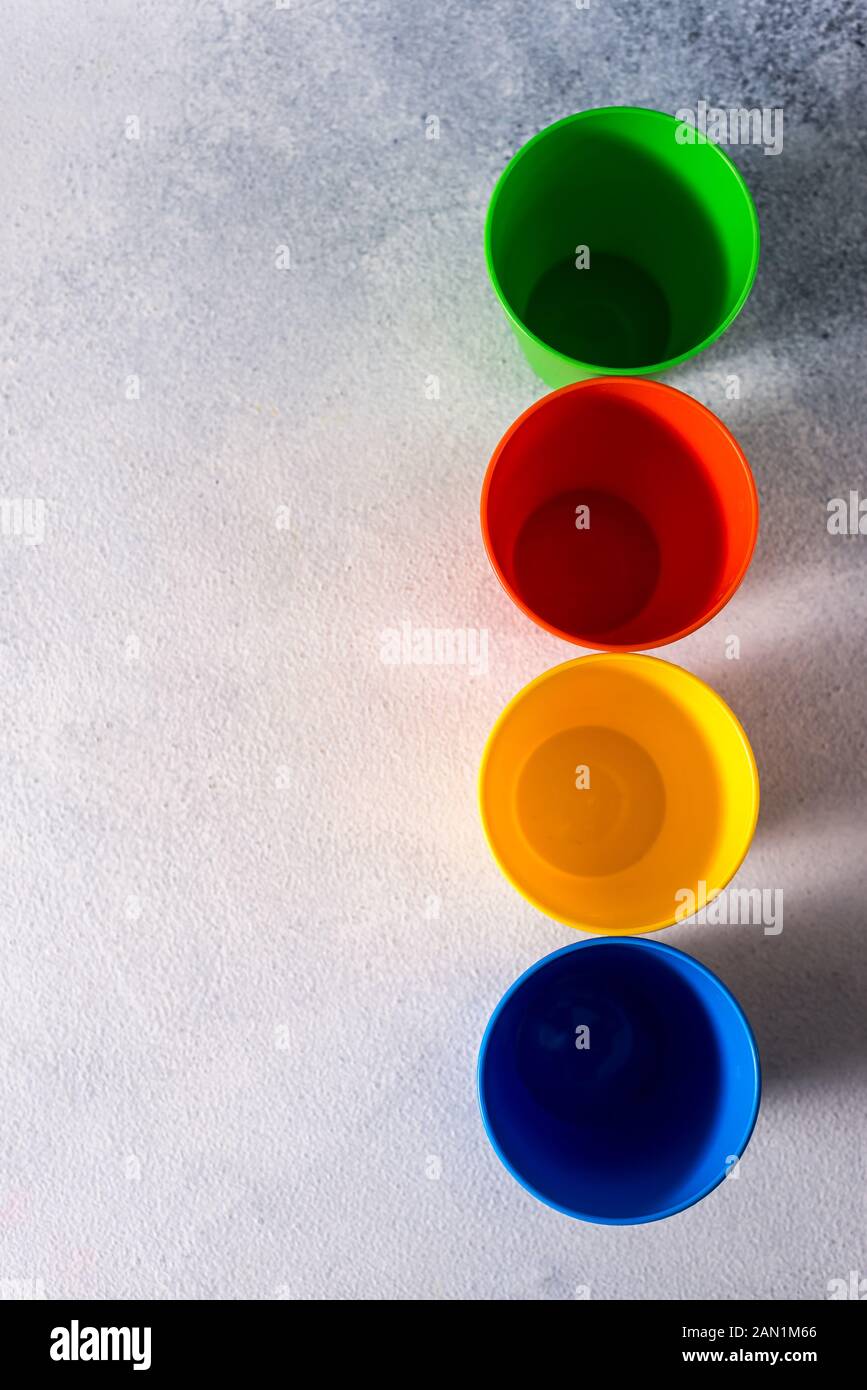 group color plastic cups on gray stone background plastic waste Stock ...