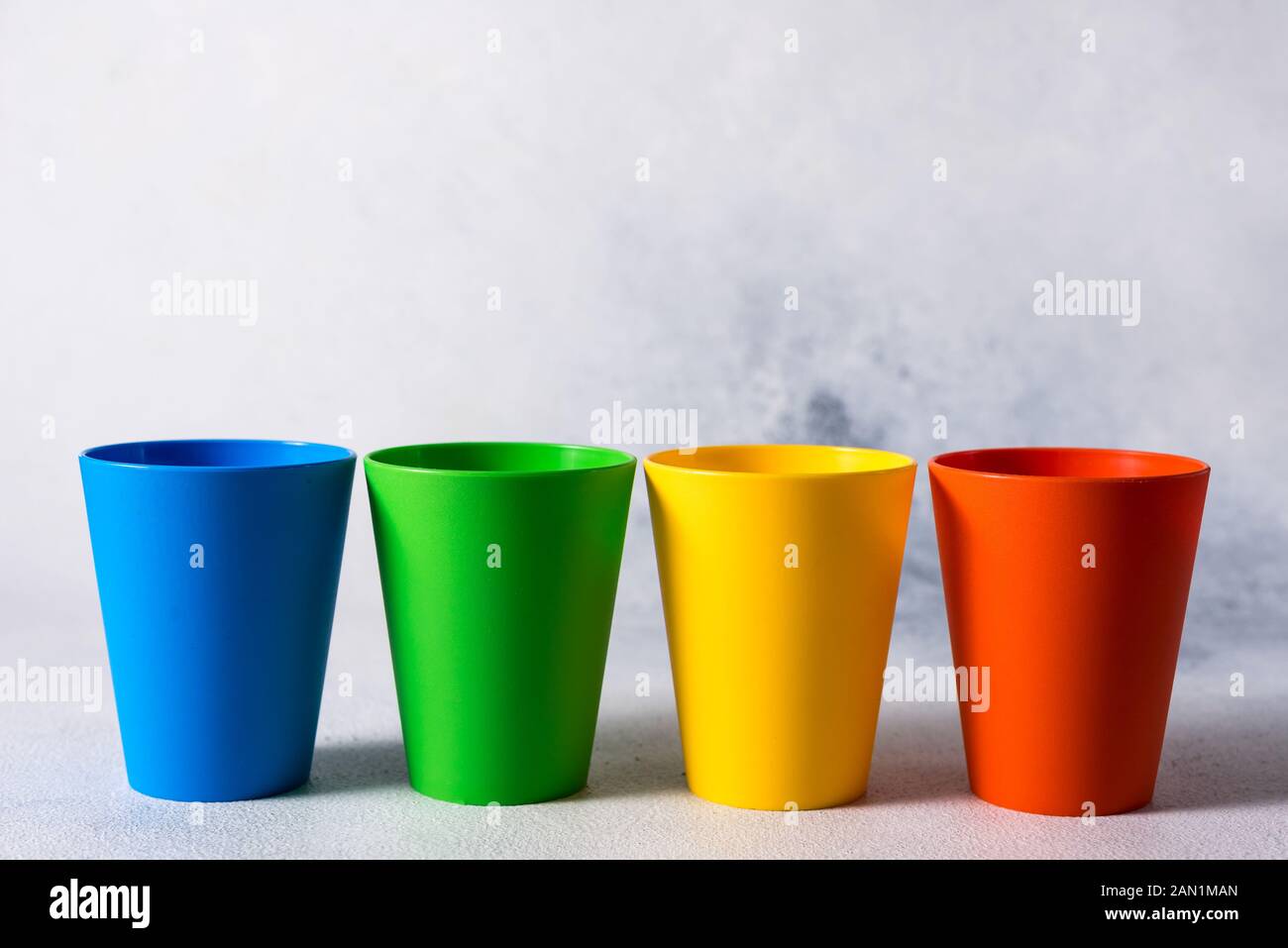 group color plastic cups on gray stone background plastic waste Stock ...