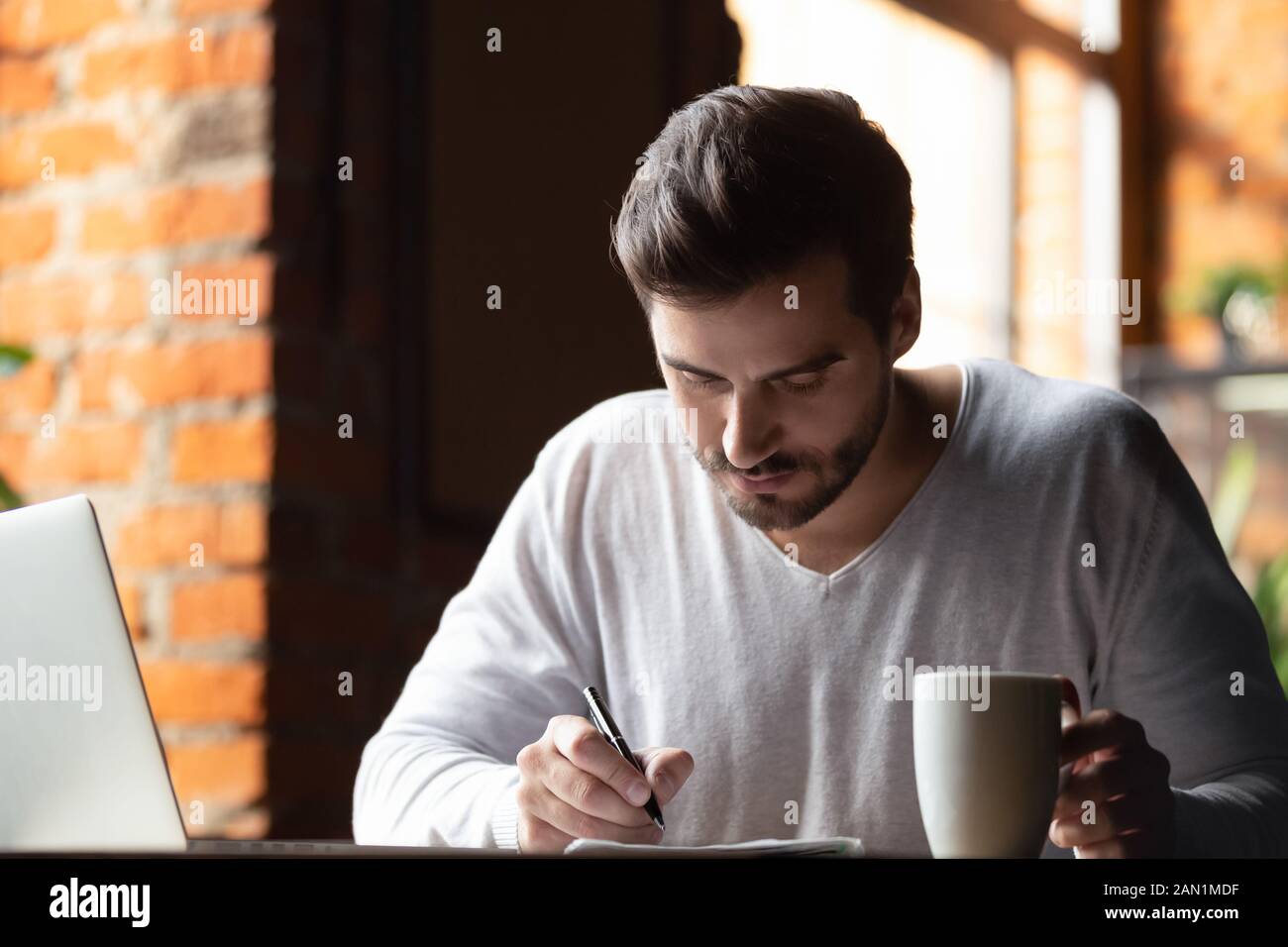 Focused male student make notes studying in cafe Stock Photo - Alamy Focused male student make notes studying in cafe Stock Photo - Alamy