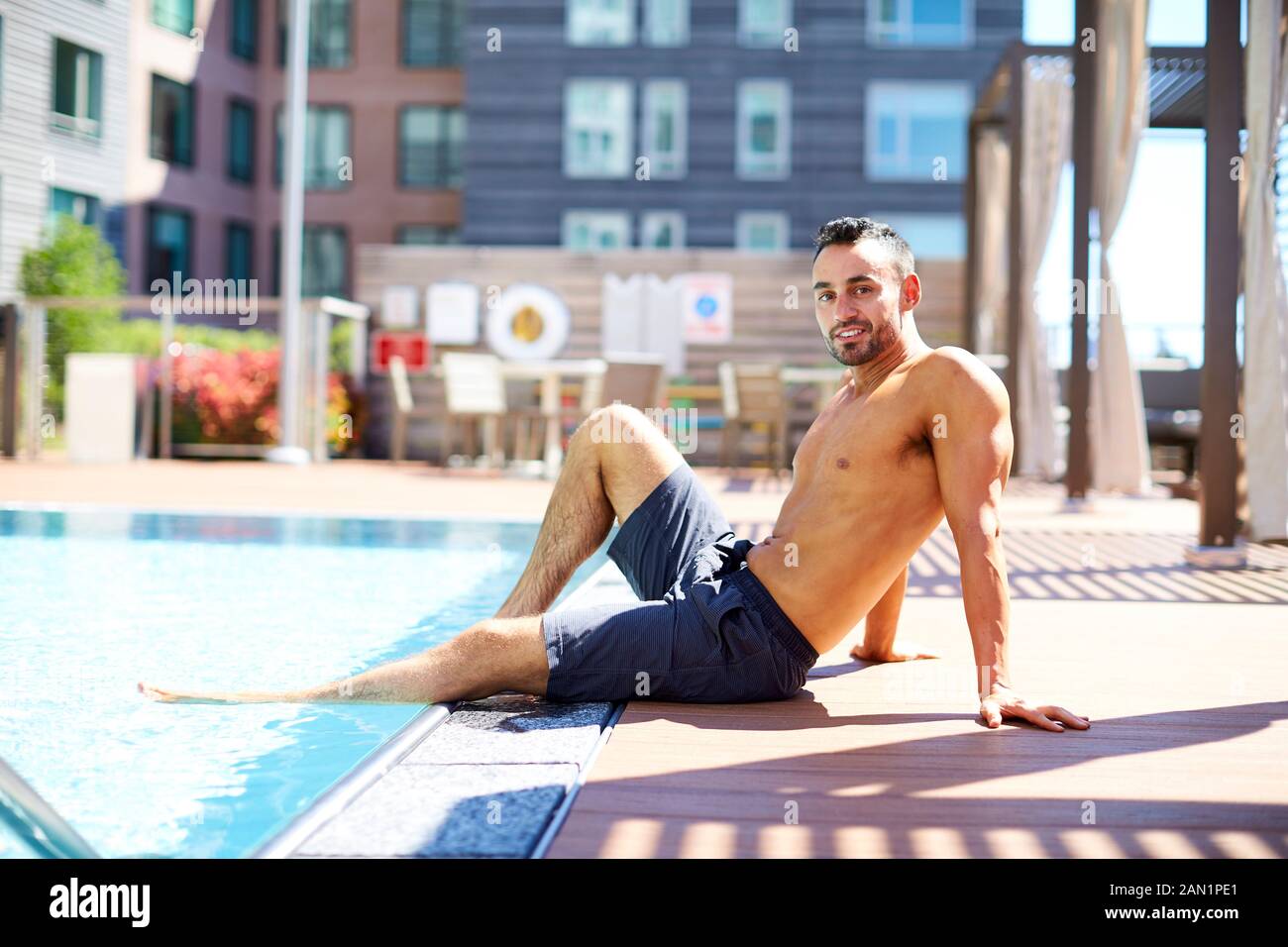 A fit man relaxes by the pool Stock Photo - Alamy