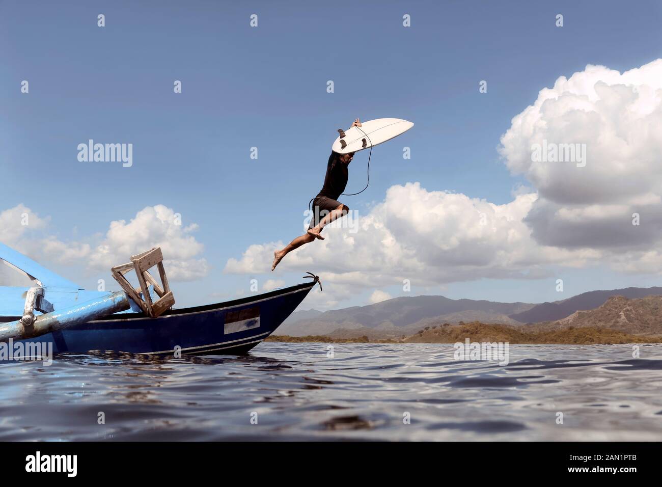 Man jumping from boat into sea Stock Photo - Alamy