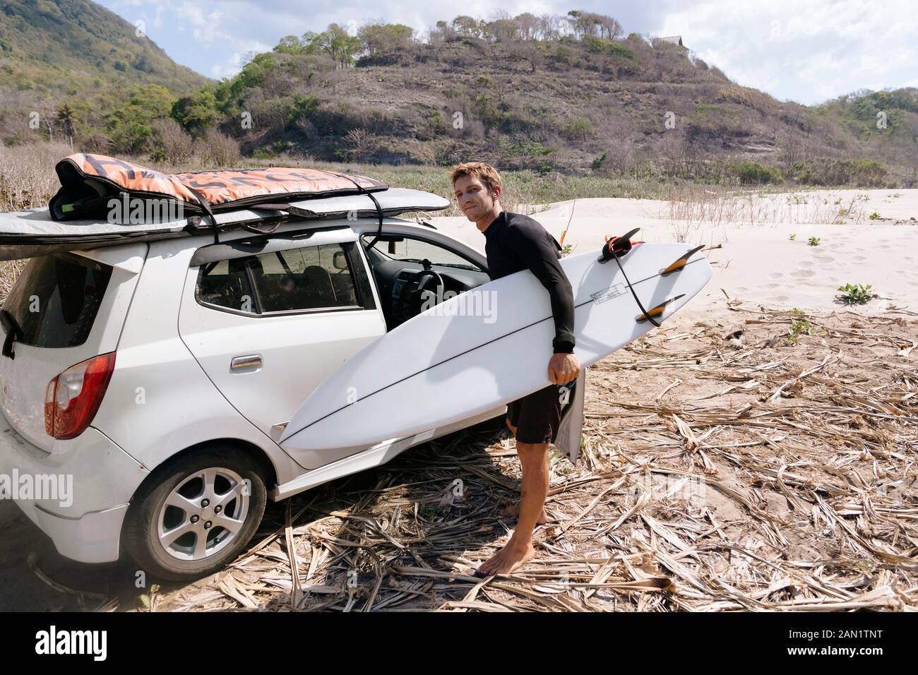 Smiling young surfer man hi-res stock photography and images - Alamy