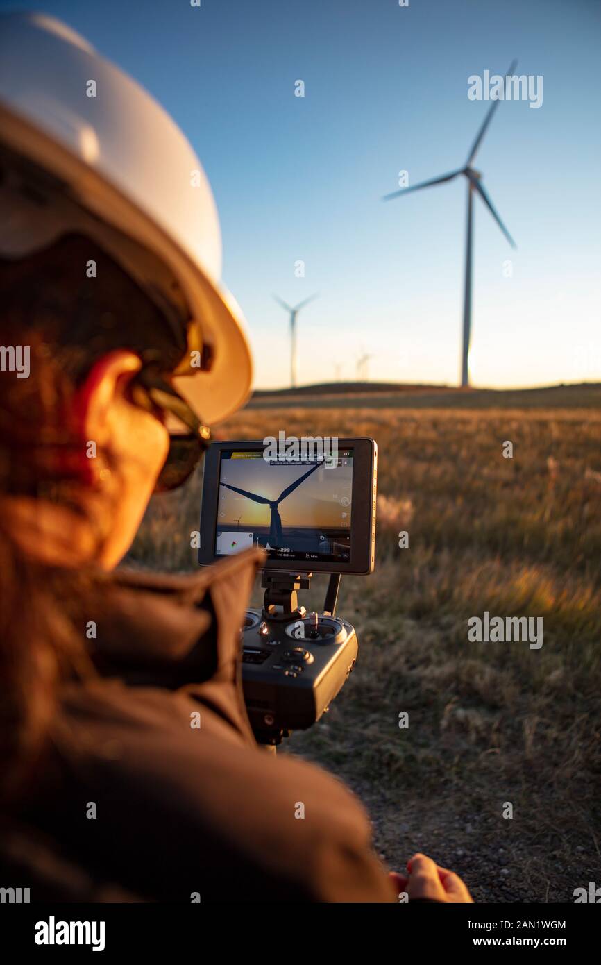 Female drone pilot flies in a wind farm at sunrise Stock Photo - Alamy