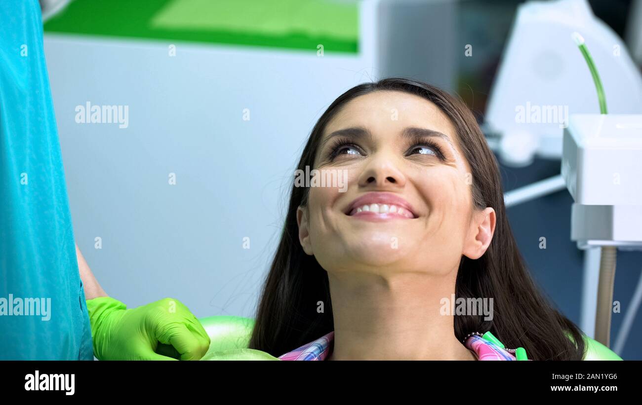 Satisfied client after regular dental examination of oral cavity ...