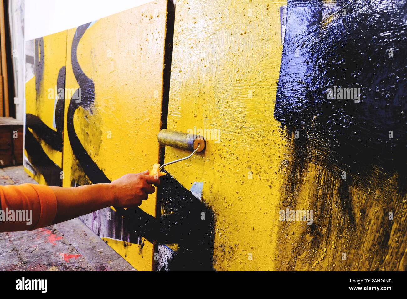 Artist's painting process . Caucasian artist working in studio. Abstra ...