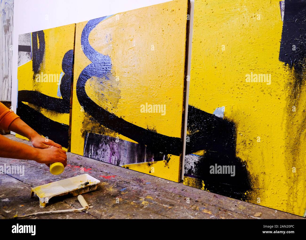 Artist's painting process . Caucasian artist working in studio. Abstra ...