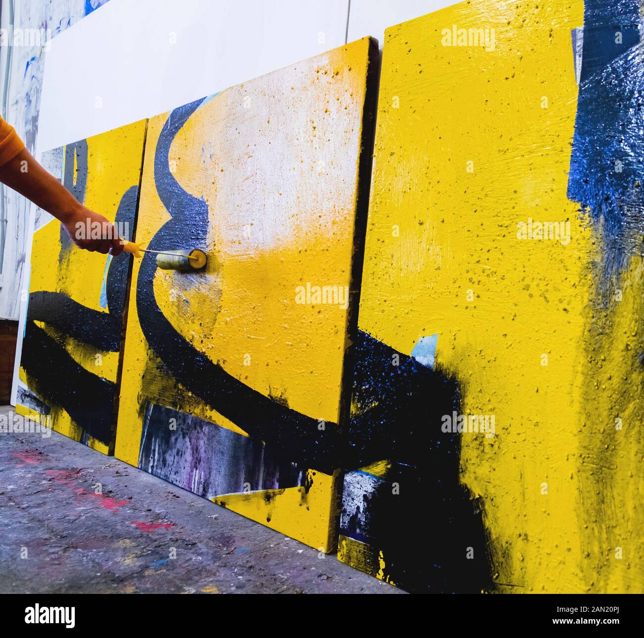 Artist's painting process . Caucasian artist working in studio. Abstra ...