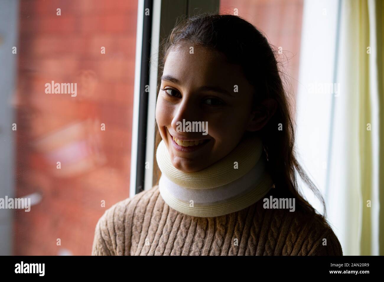 Young woman with a cervical collar smiling. Neck brace and traffic ...
