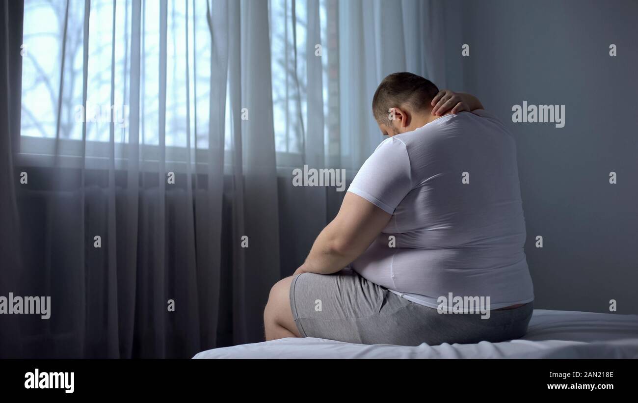 Fat man massaging neck, back pain problem, lack physical activity ...
