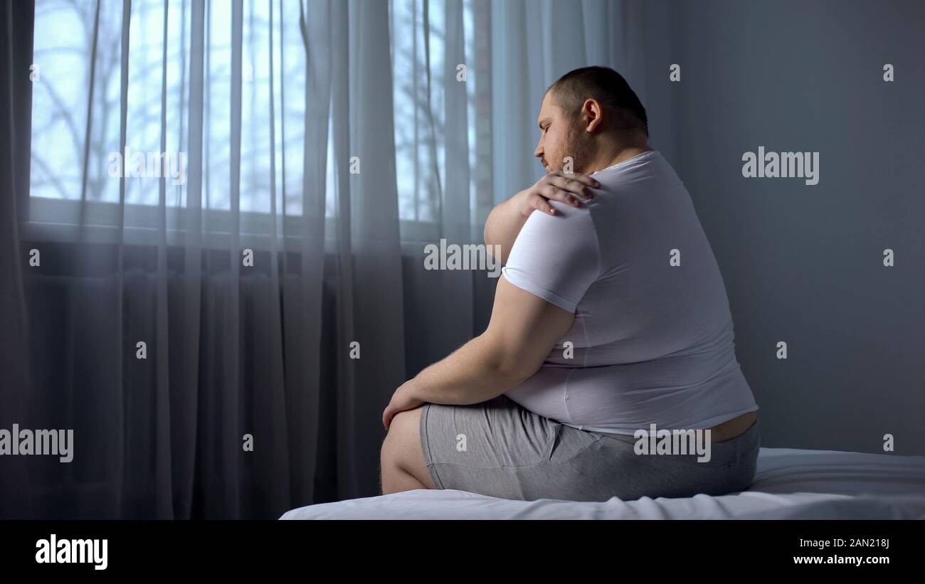 Obese male massaging shoulder muscles, orthopedic and rheumatologic ...