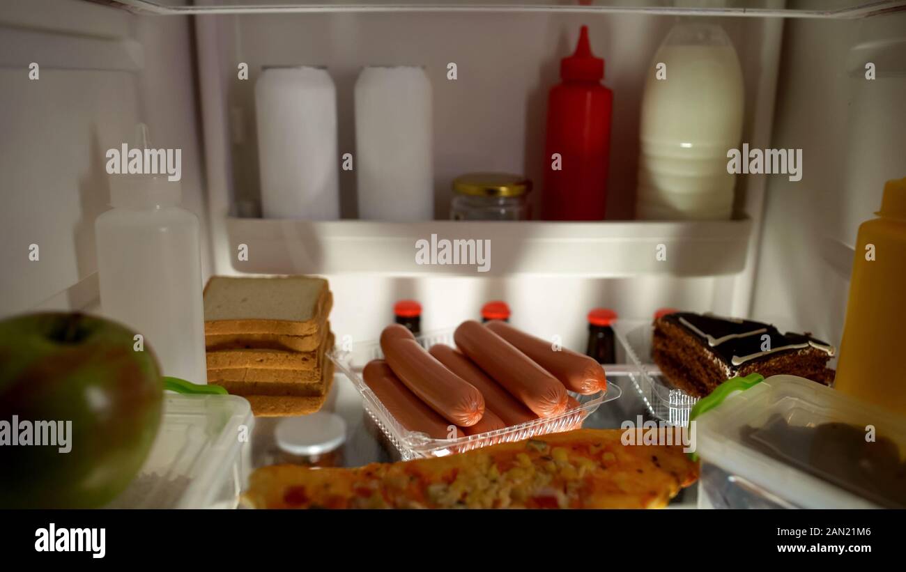 Fridge filled with junk food, unhealthy nutrition concept, high calorie ...