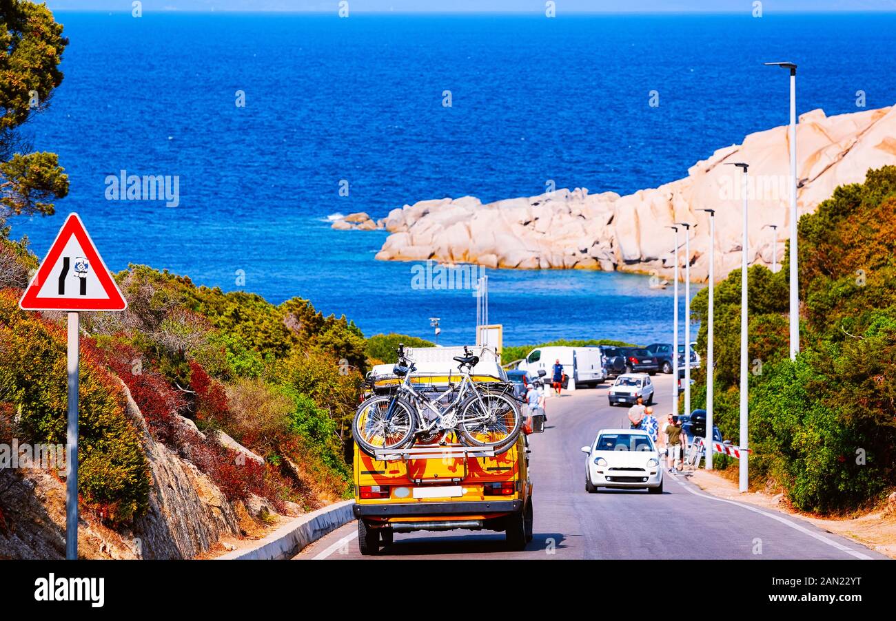Camper car with bicycles driving in highway road Capo Testa reflex ...