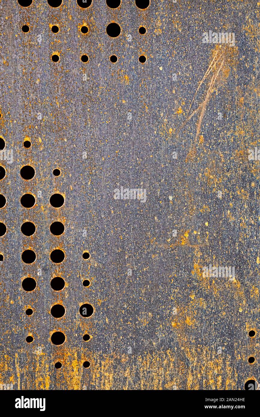 rusted originally black colored metal with circular holes Stock Photo ...