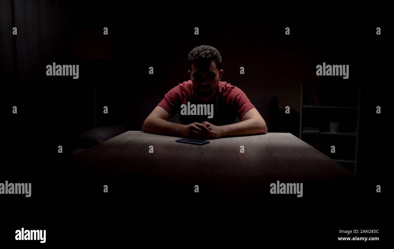 Single man sitting hi-res stock photography and images - Alamy