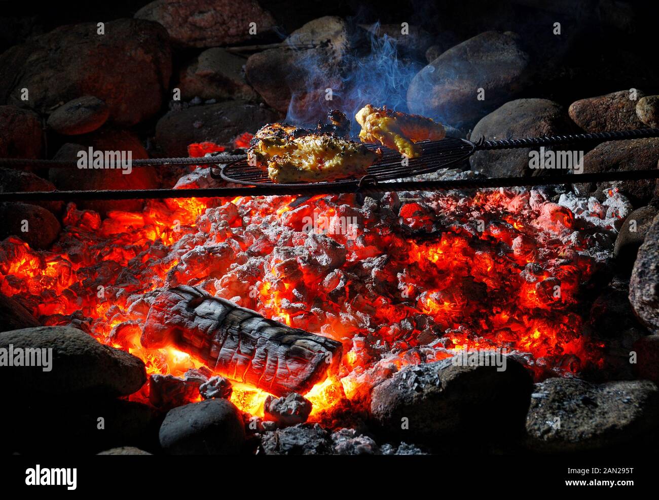 Two pieces of chicken lying on improvised campfire barbecue Stock Photo ...