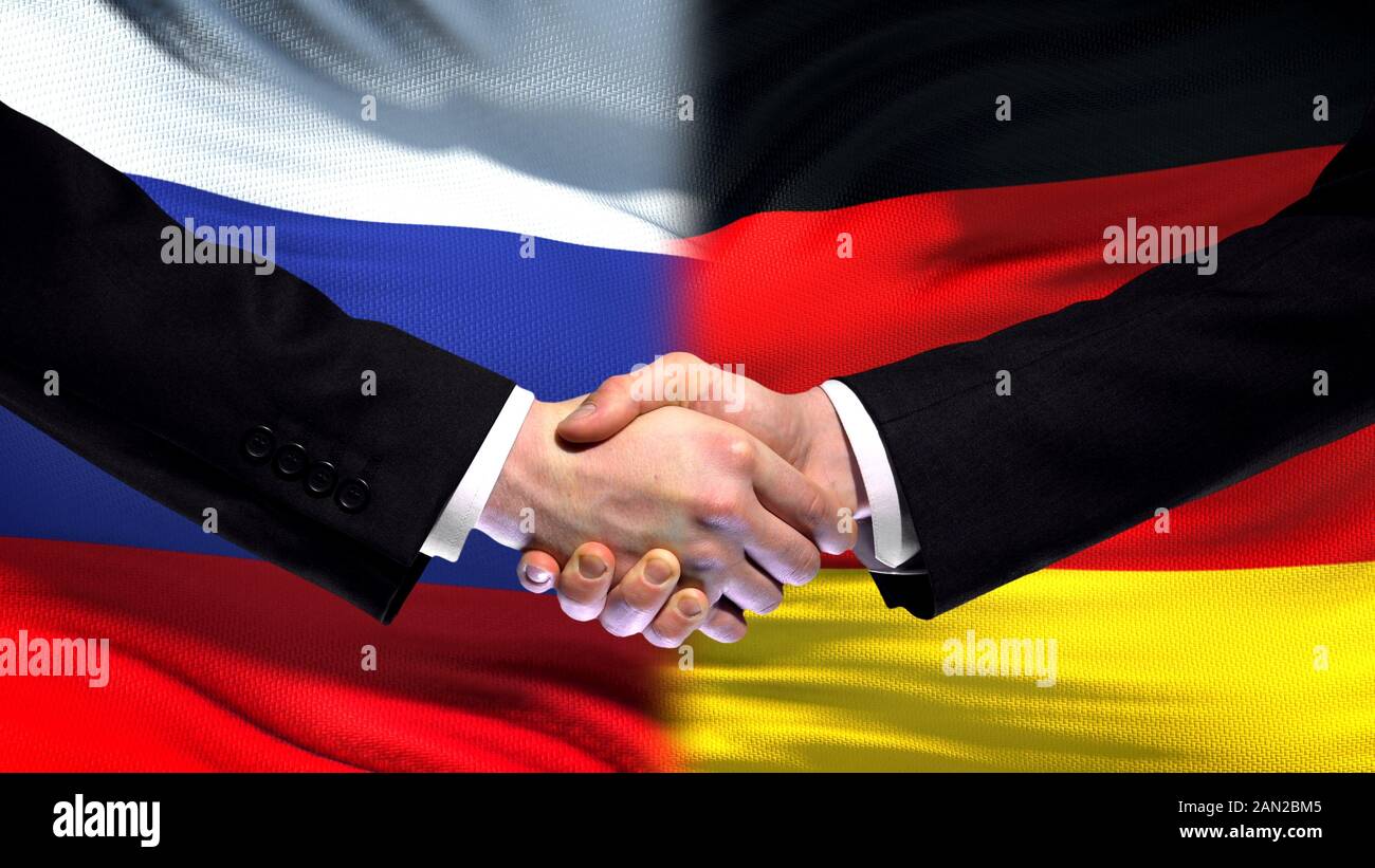Russia and Germany handshake, international friendship summit, flag ...