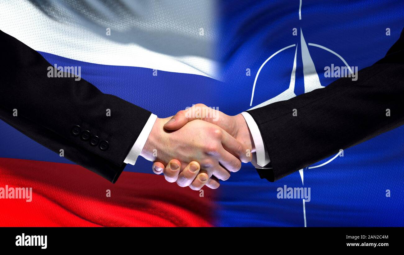 Russia and NATO handshake, international friendship relations, flag ...
