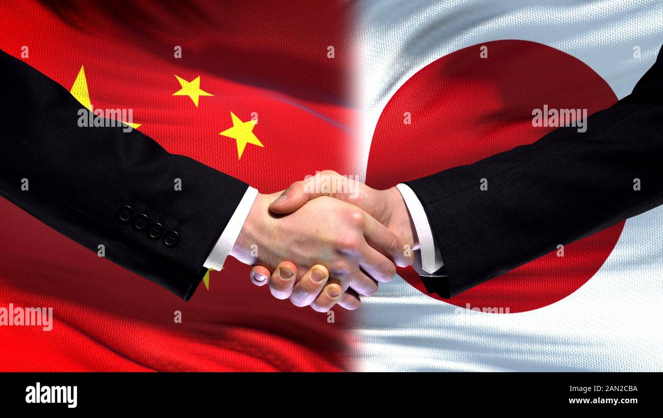 China and Japan handshake, international friendship relations, flag ...