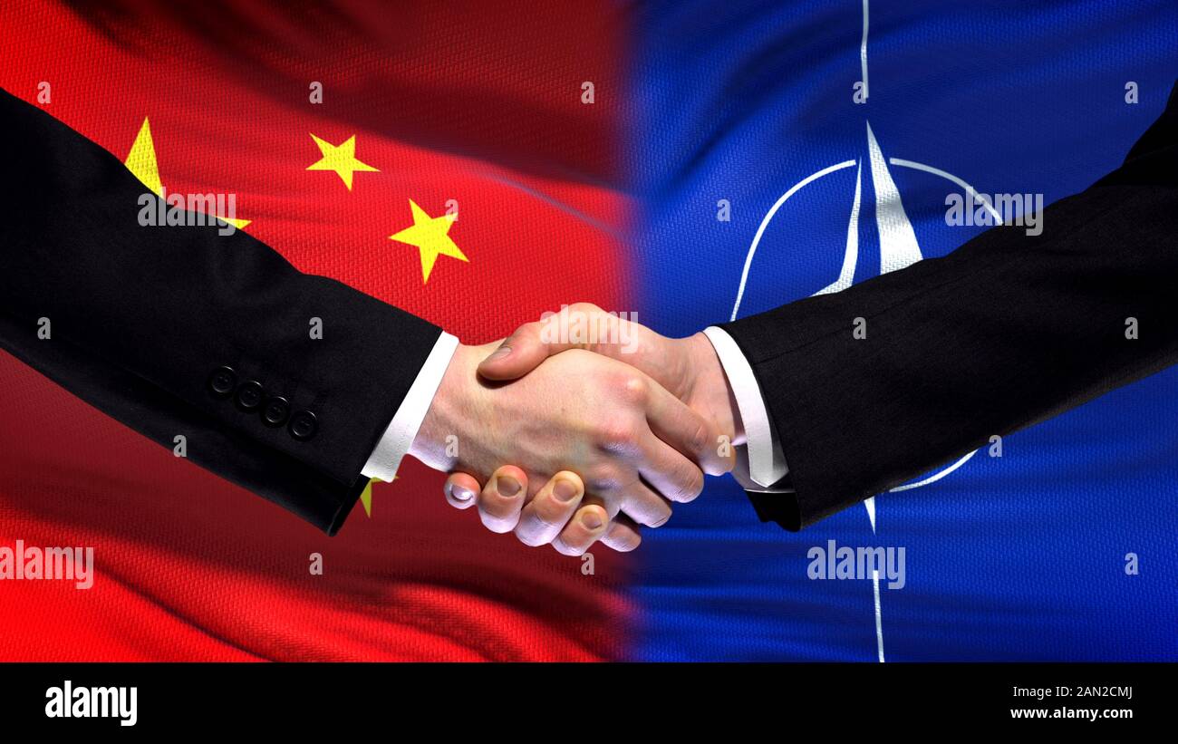 China and NATO handshake, international friendship relations, flag ...