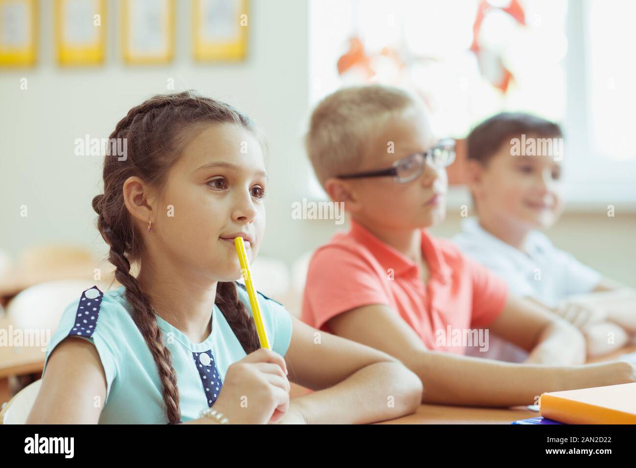 Happy schoolchildren studing and answer questions in classroom during a ...