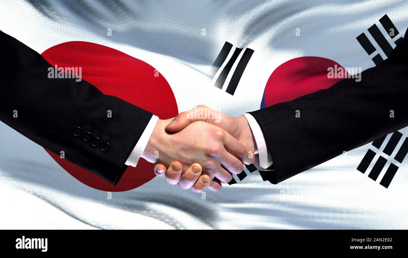 Japan and South Korea handshake international friendship summit, flag ...