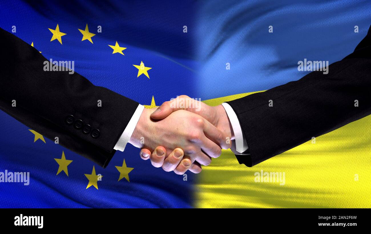 European Union and Ukraine handshake, international friendship, flag ...