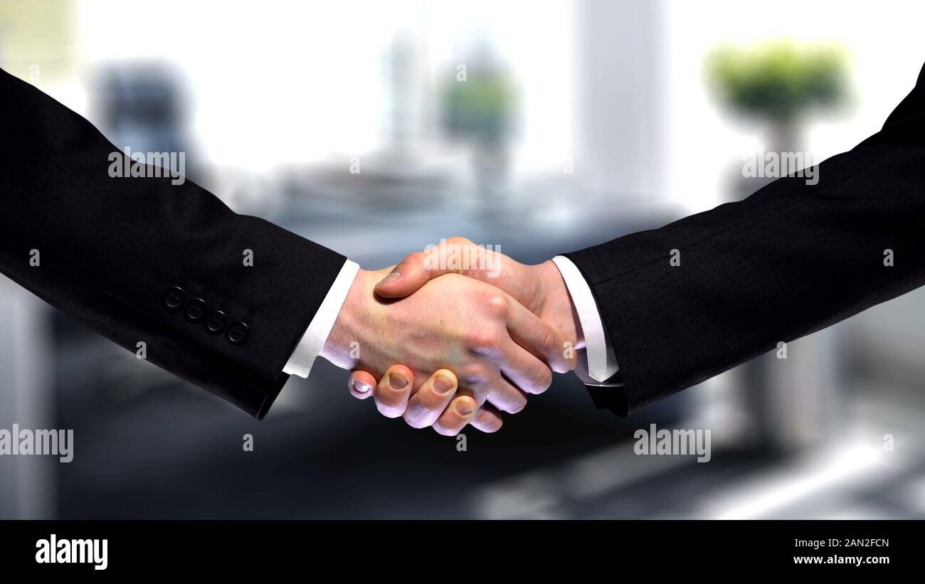Business handshake on company office background, partnership trust ...