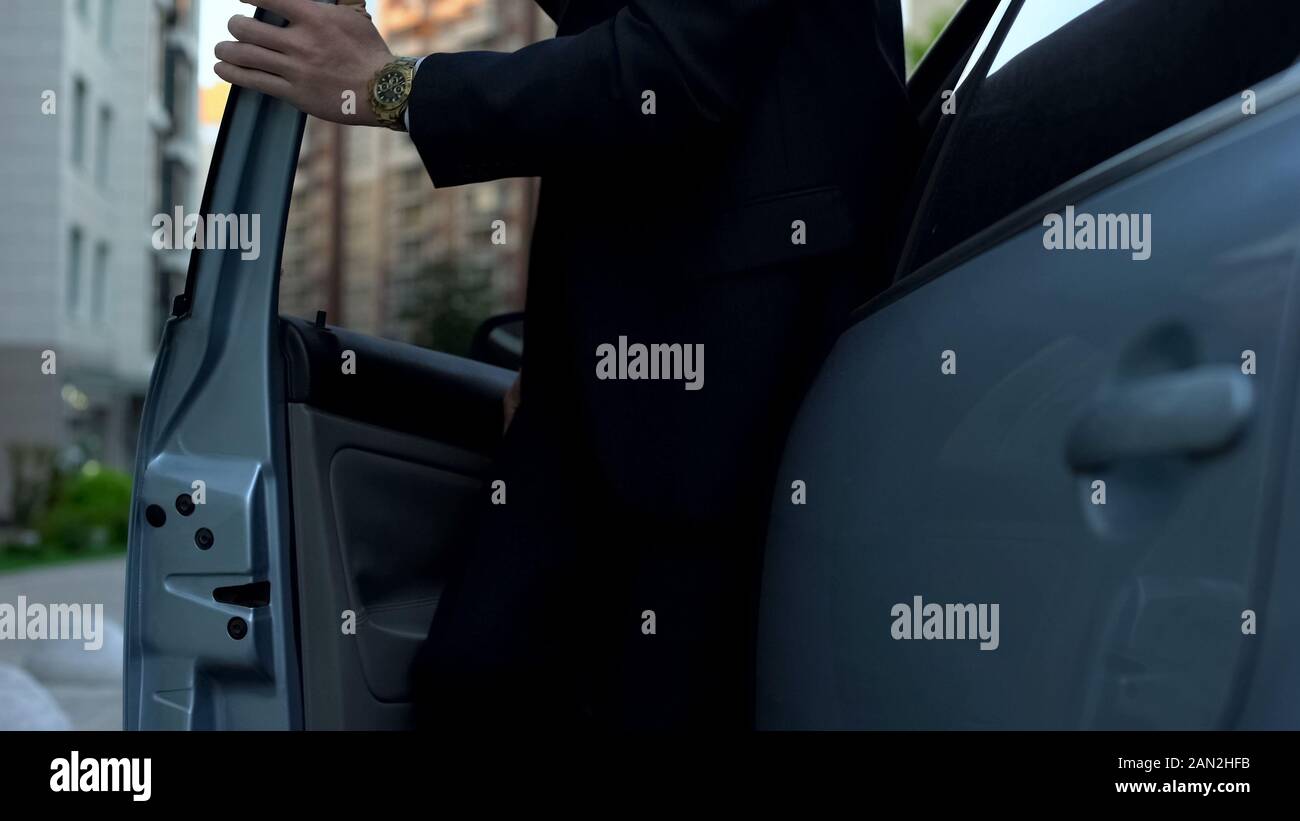 Tired man getting out of car, returning home from work, daily routine ...