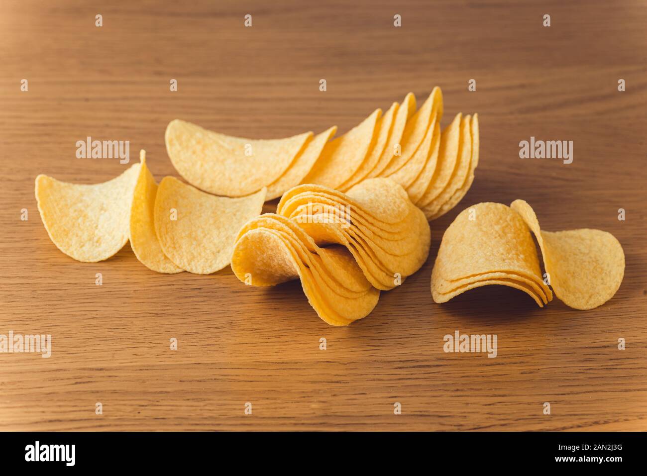 Delicious potato chips, laying on wooden table background Stock Photo ...