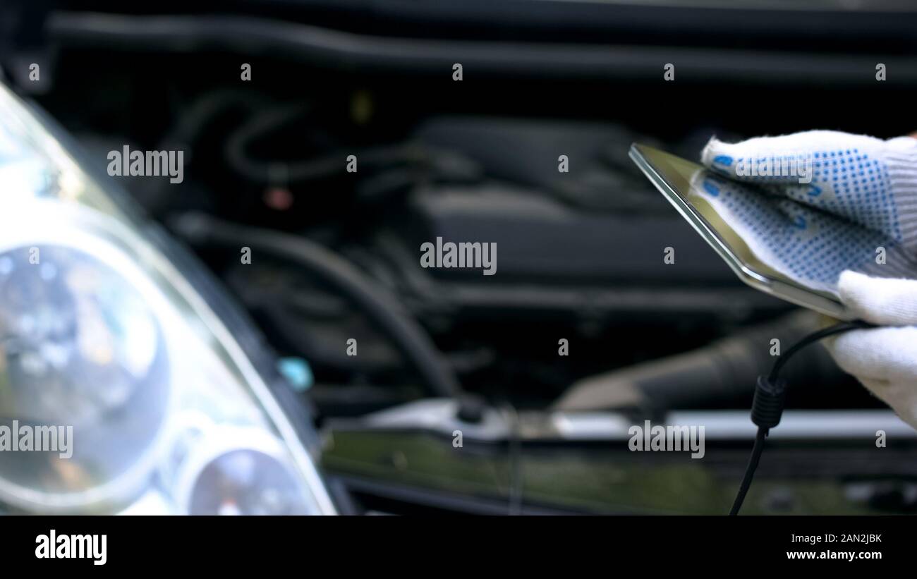 Car engine check up with tablet, engineer uses computer technologies ...