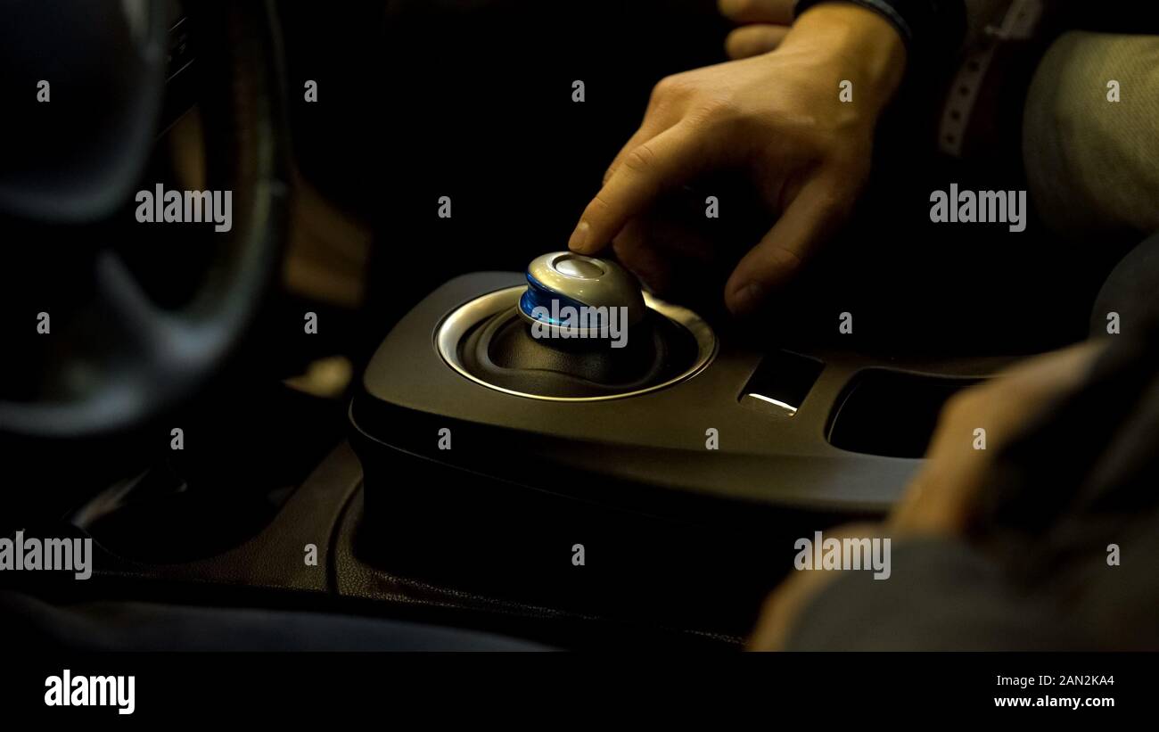 Automobile salesman demonstrating new electric car transmission, smart ...