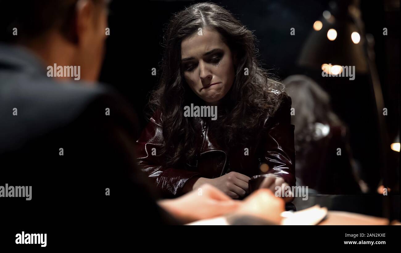 Detective interrogating crying lady, trying to get signed confession ...