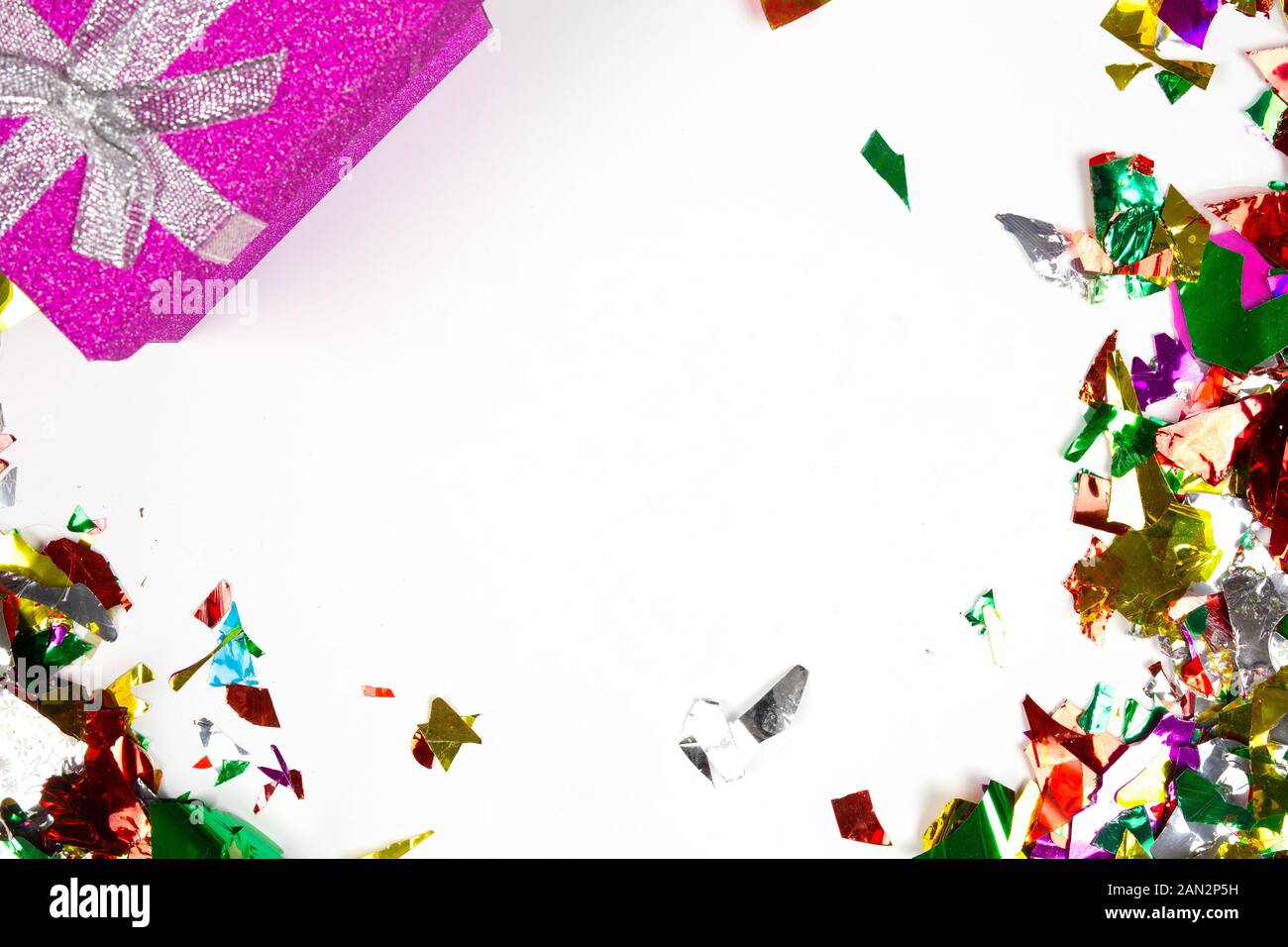 Multi-colored confetti and colorful presents isolated on white ...