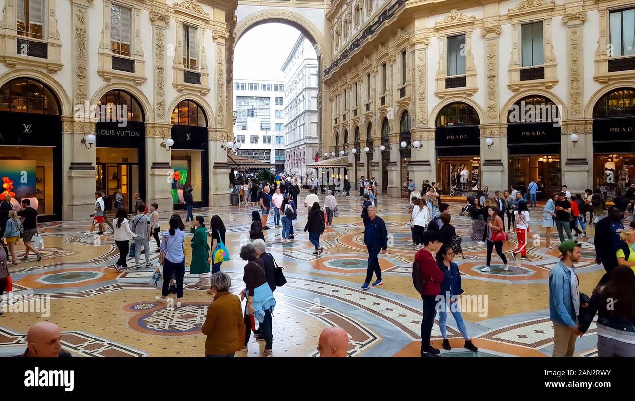 Tourists shopping in famous Milan city mall, Italian architecture ...