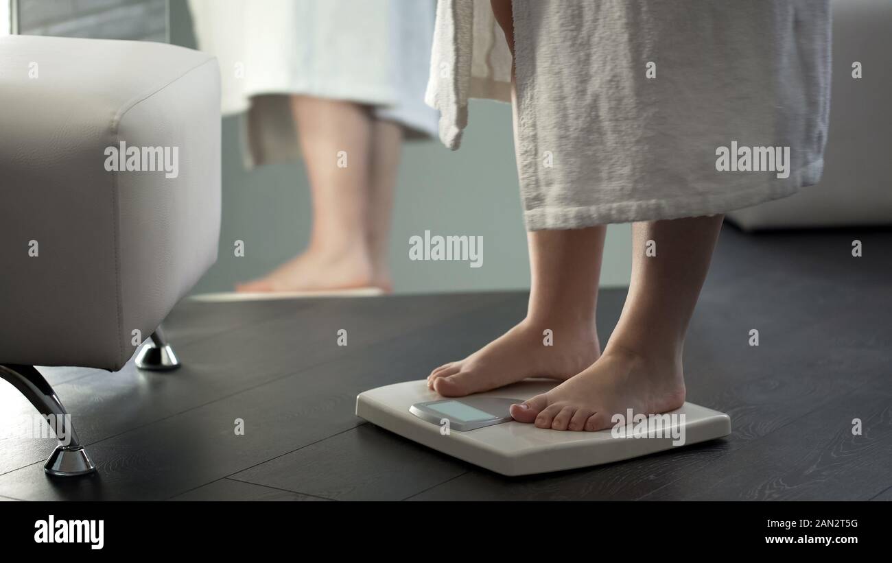 Healthy dieting, woman standing on scales to see result, normal weight ...