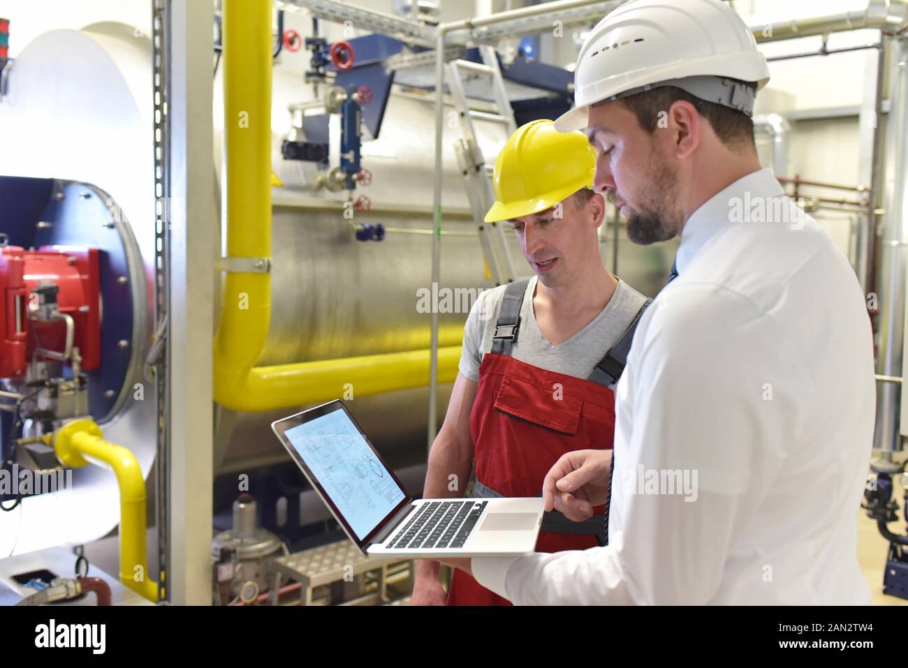 businessman and worker meeting in a factory - maintenance and repair of ...
