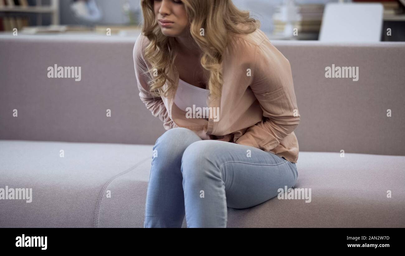 Girl suffering from stomach pain, premenstrual syndrome spasms, women ...