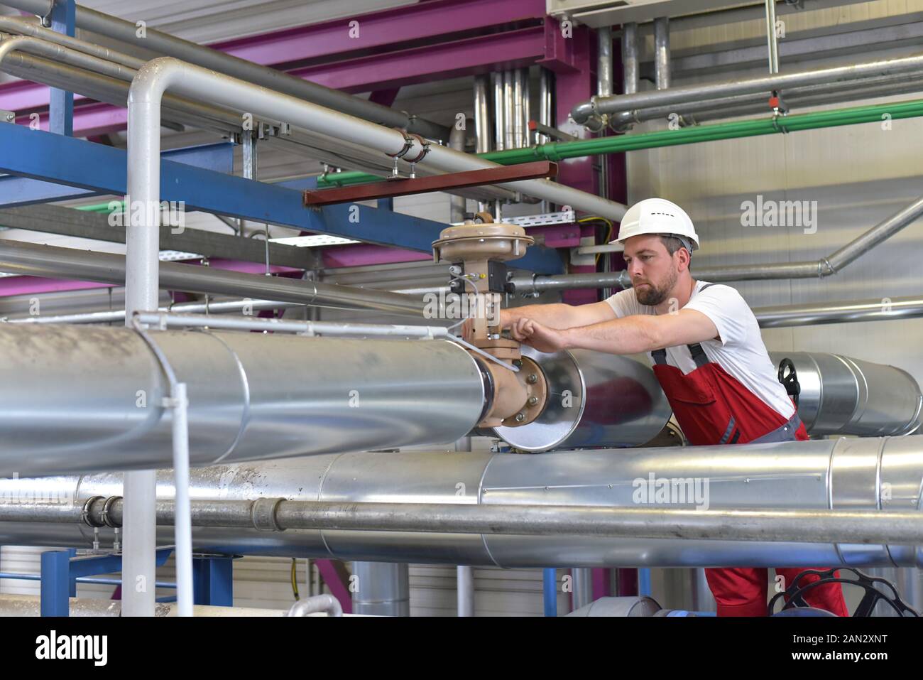 Mechanics repair a machine in a modern industrial plant - profession ...